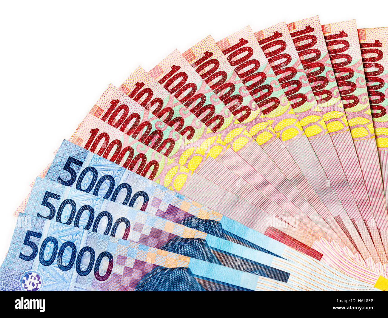 Piles of Indonesian Rupiah (IDR) banknotes on the white background ...