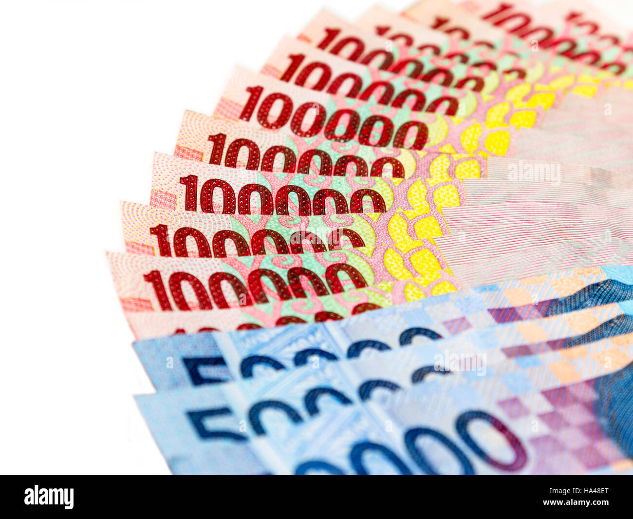 Piles of Indonesian Rupiah (IDR) banknotes on the white background ...