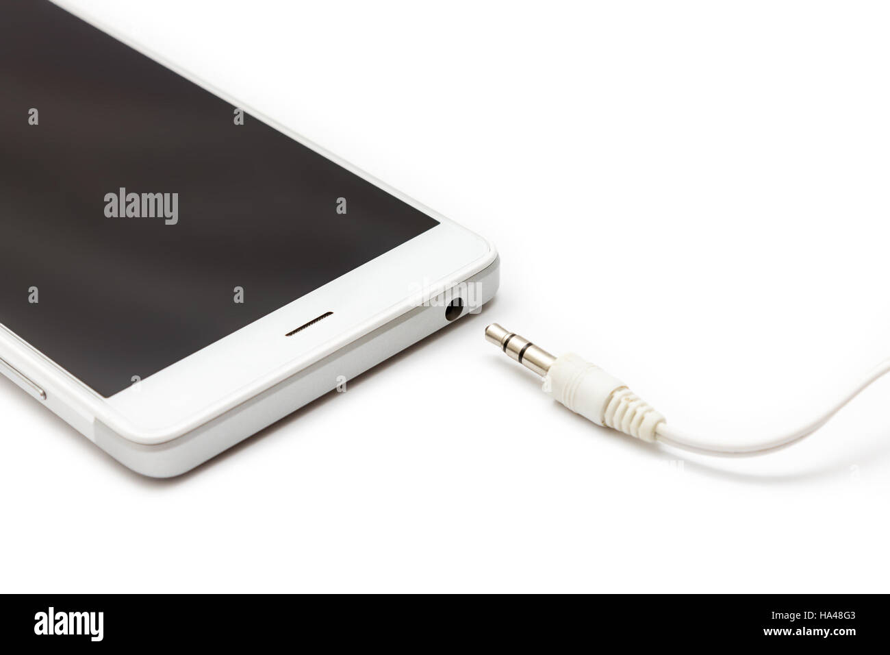 Mini audio cable disconnected from the smartphone. White background ...