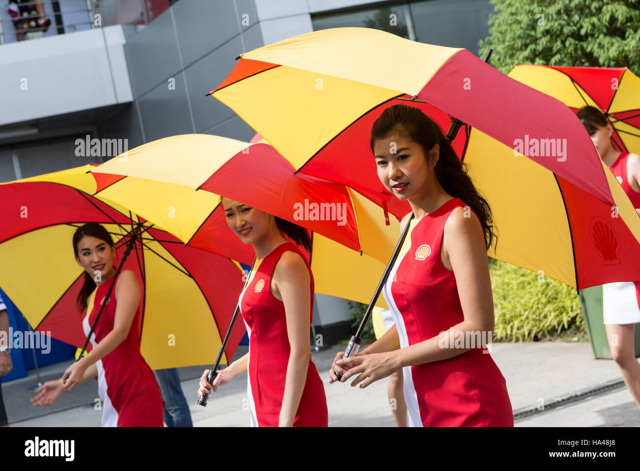 Pit girls in the uniform of Shell in the paddock during the Malaysian ...