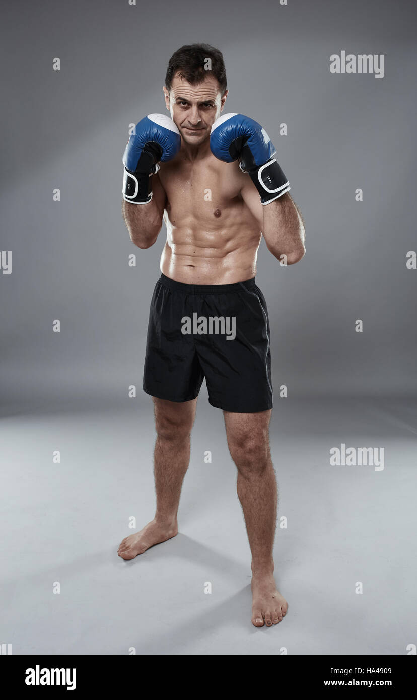 Kickbox fighter in guard stance full length on gray background Stock ...