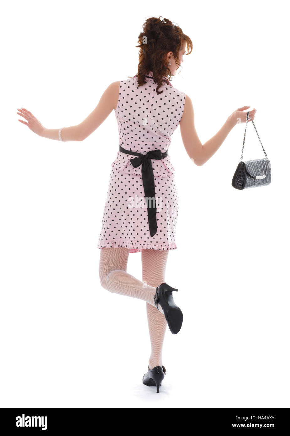 A young fashionable young woman dressed in a trendy, glamorous outfit ...