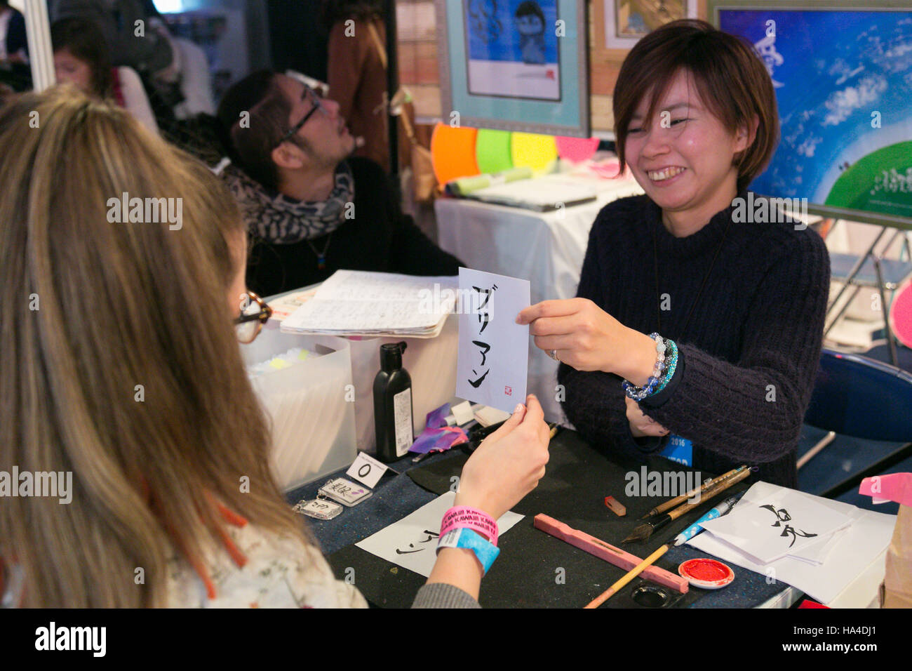 A foreign visitor receives her name in Japanese alphabet during the ...