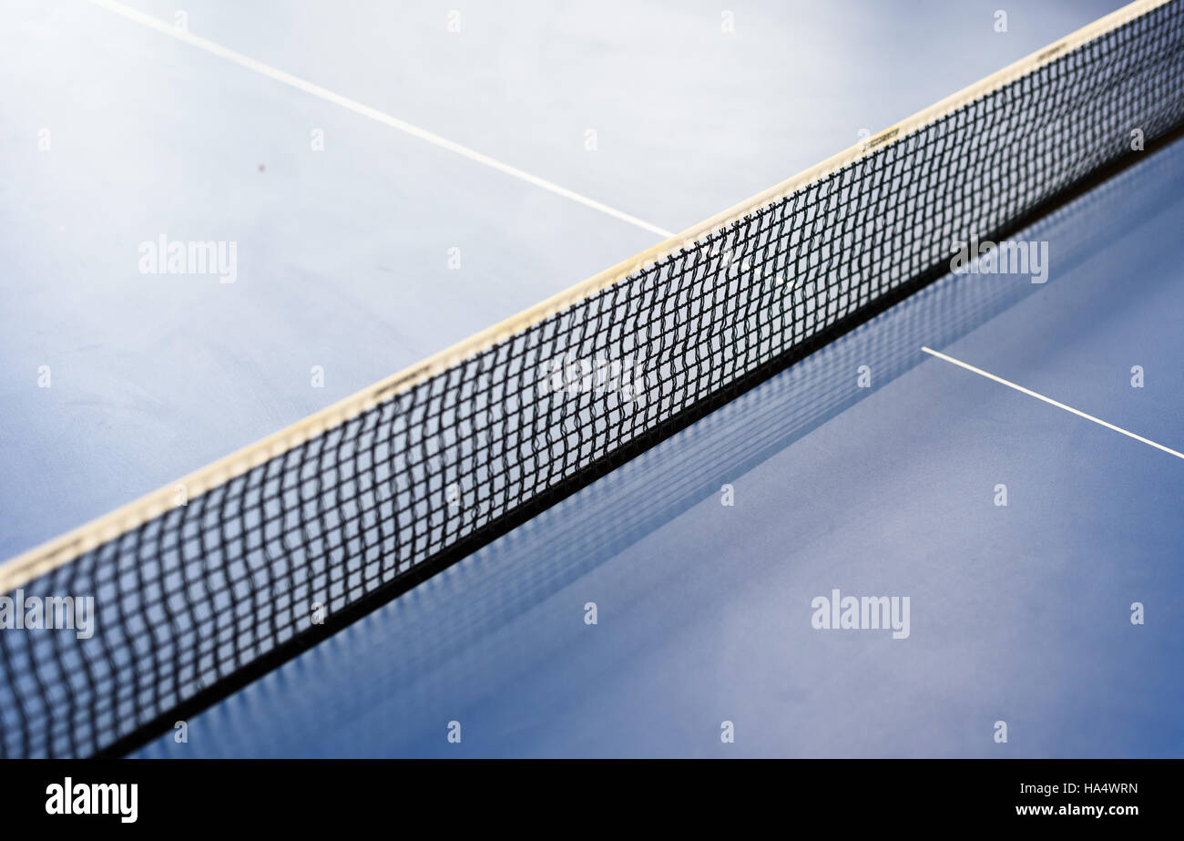 Diagonal table tennis net on a blue tabletennis table. Copy space area ...