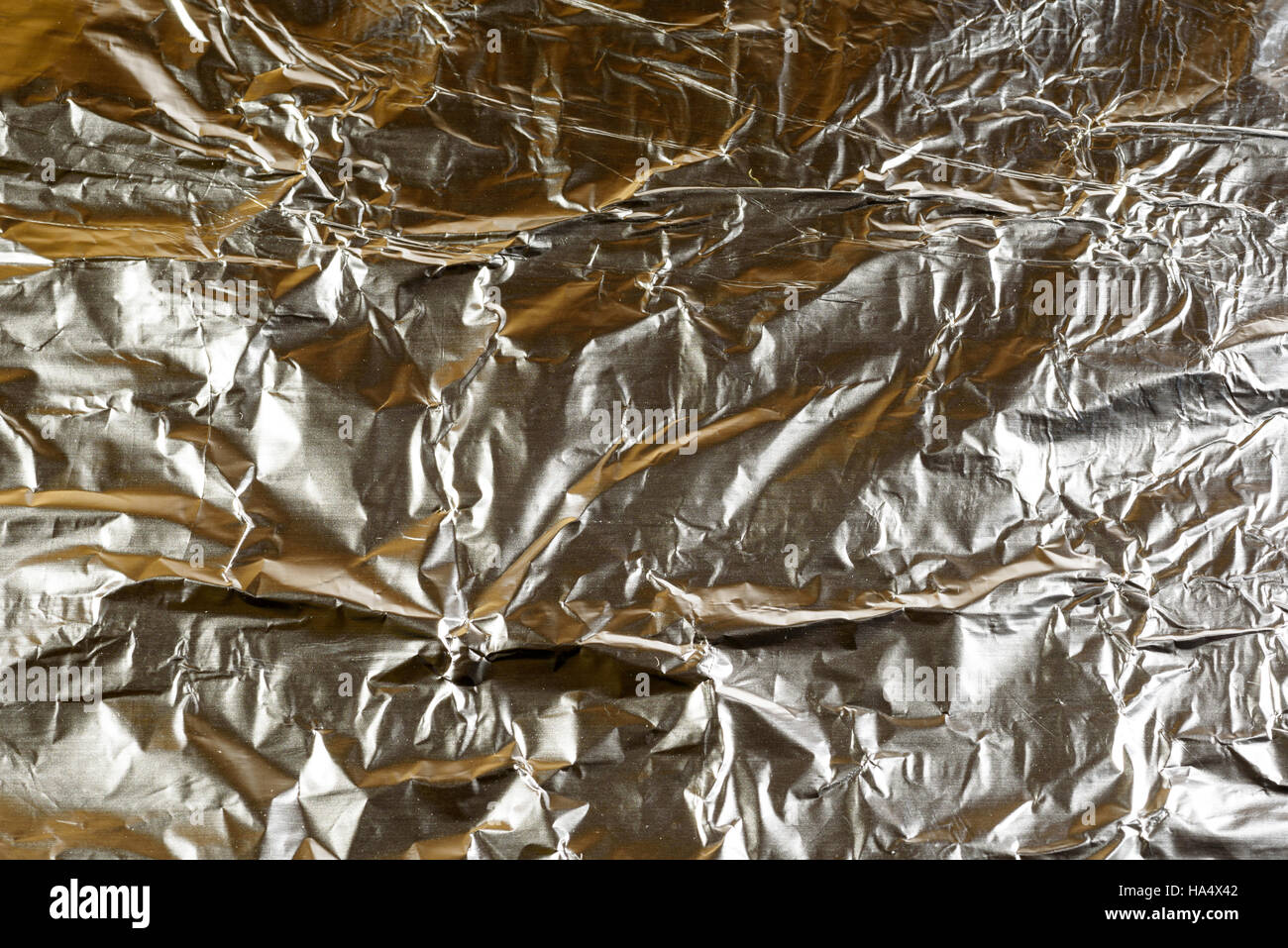 Crumpled Aluminum tin foil texture with light reflections on the shiny ...