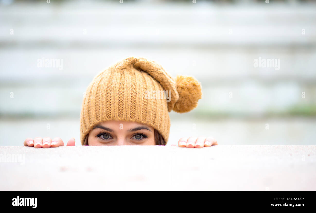 Portrait of a beautiful woman who is hiding and looks like she is ...