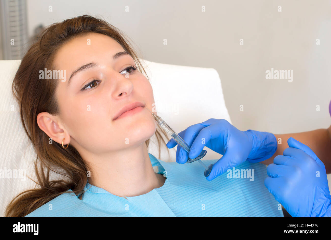 Young Woman Geting an Injection in her Lips in Beauty salon Stock Photo ...
