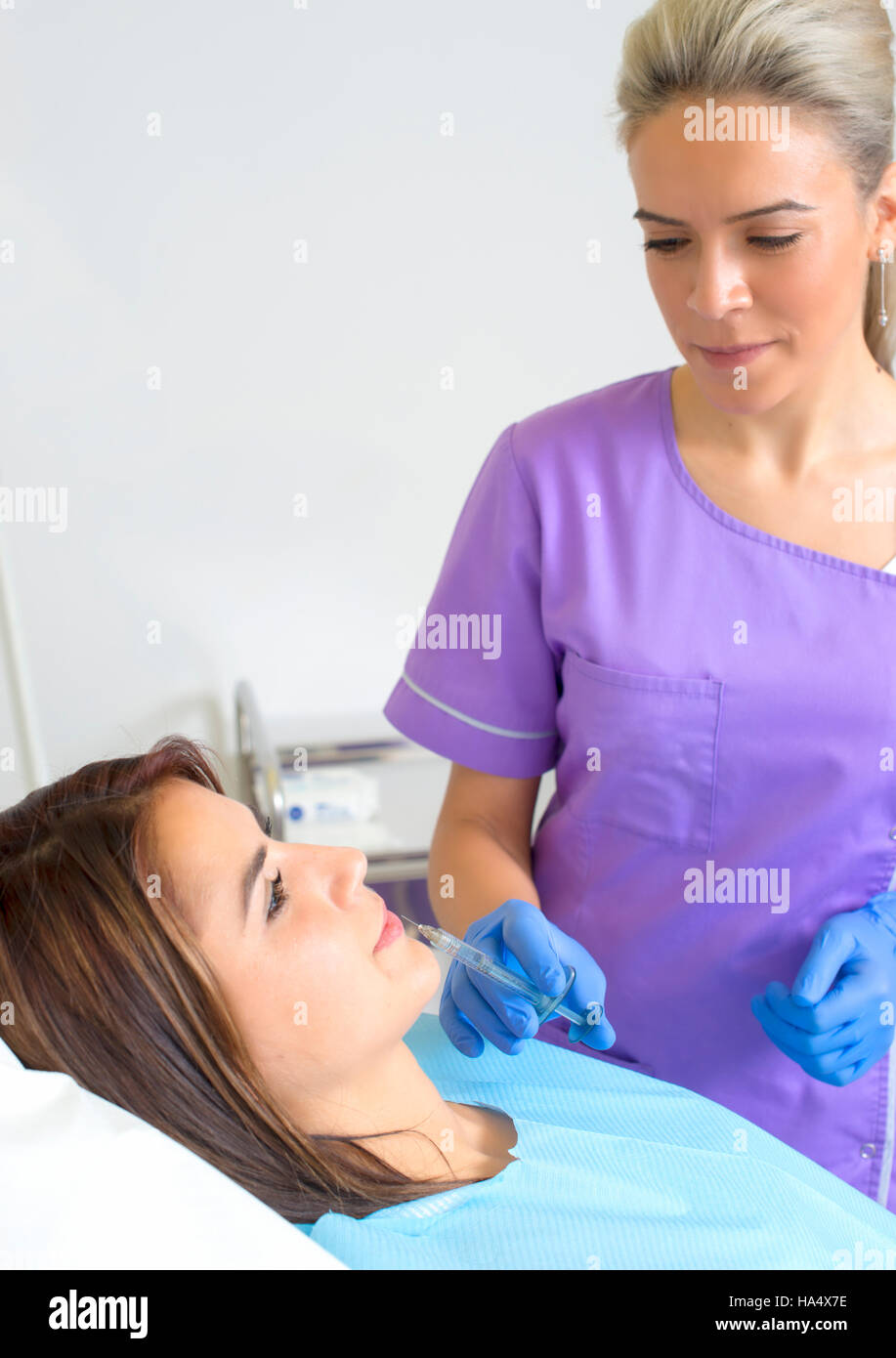 Young Woman Geting an Injection in her Lips in Beauty salon Stock Photo ...