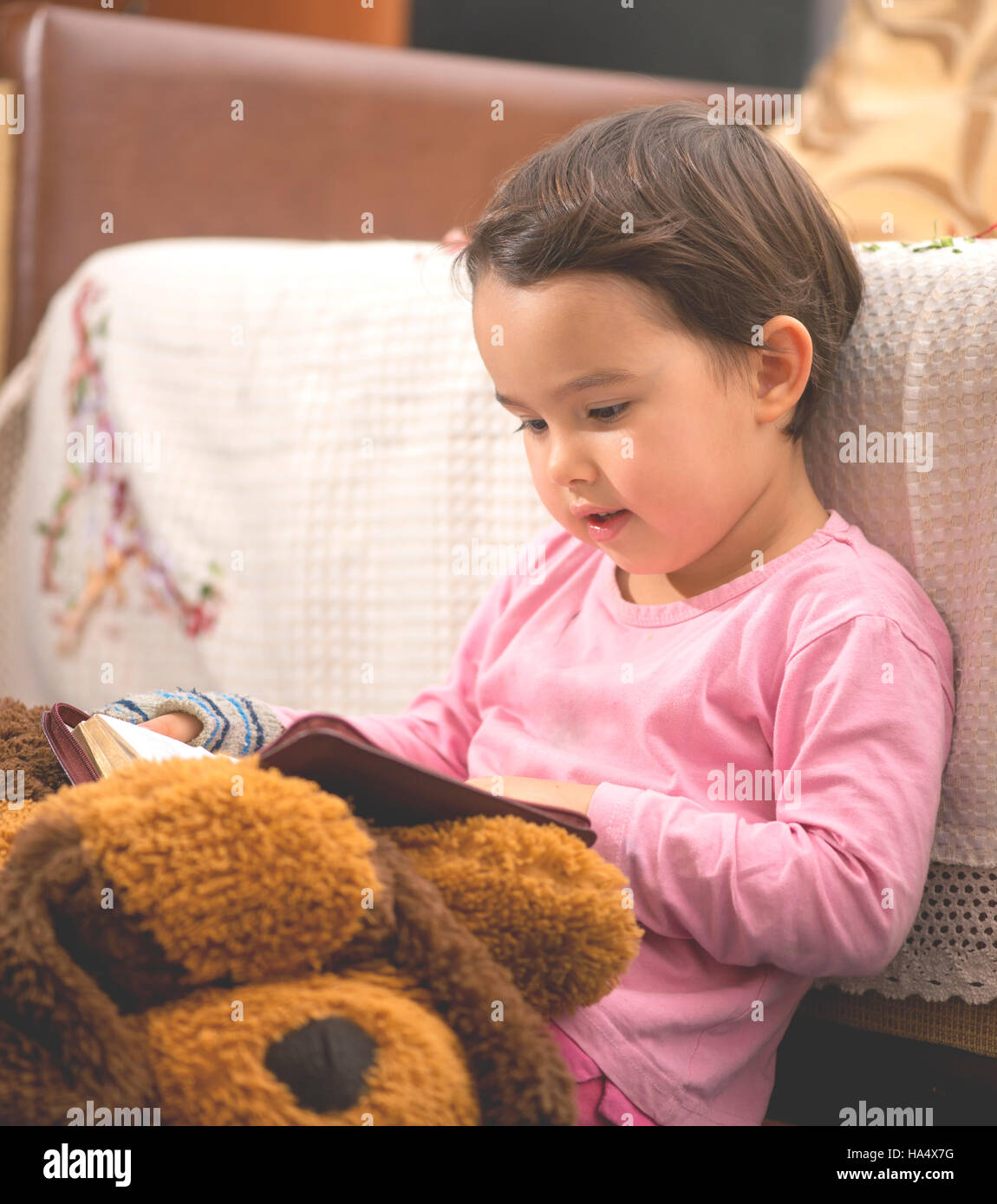 Cute little child girl reading the Bible Stock Photo - Alamy