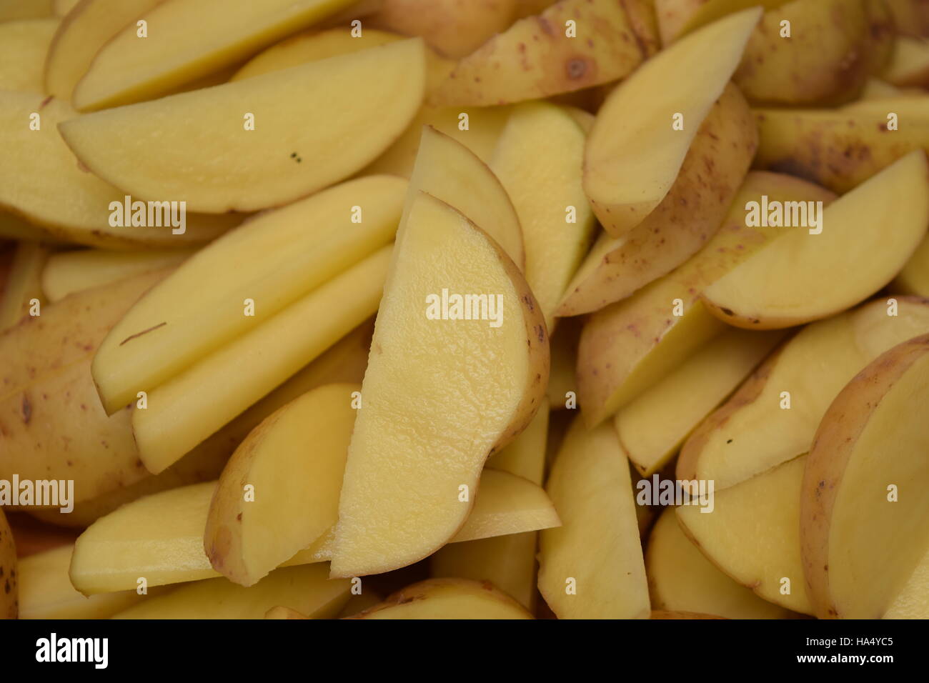 Close-up raw potato wedges Stock Photo - Alamy