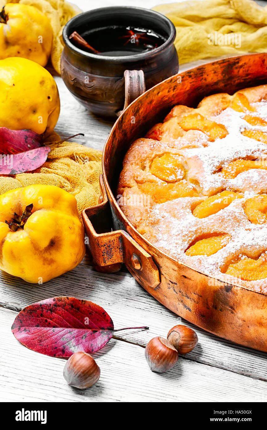 Baked pie with quince in copper kitchen form Stock Photo - Alamy
