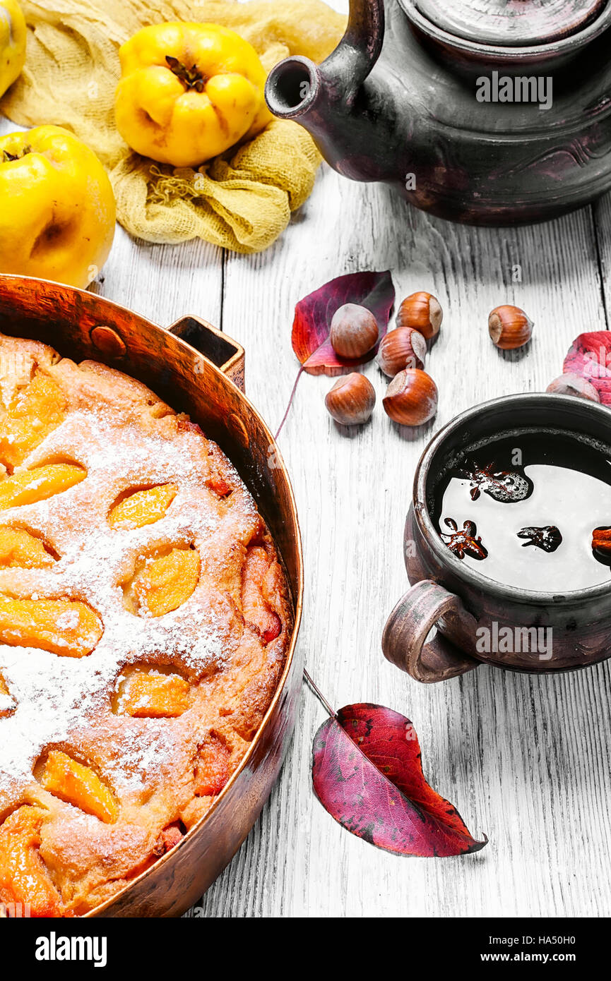 Baked pie with quince in copper kitchen form Stock Photo - Alamy