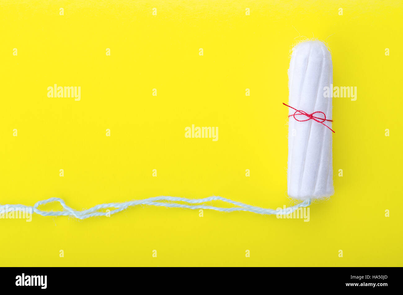 Woman hygiene protection, close-up, cotton tampons on a yellow ...