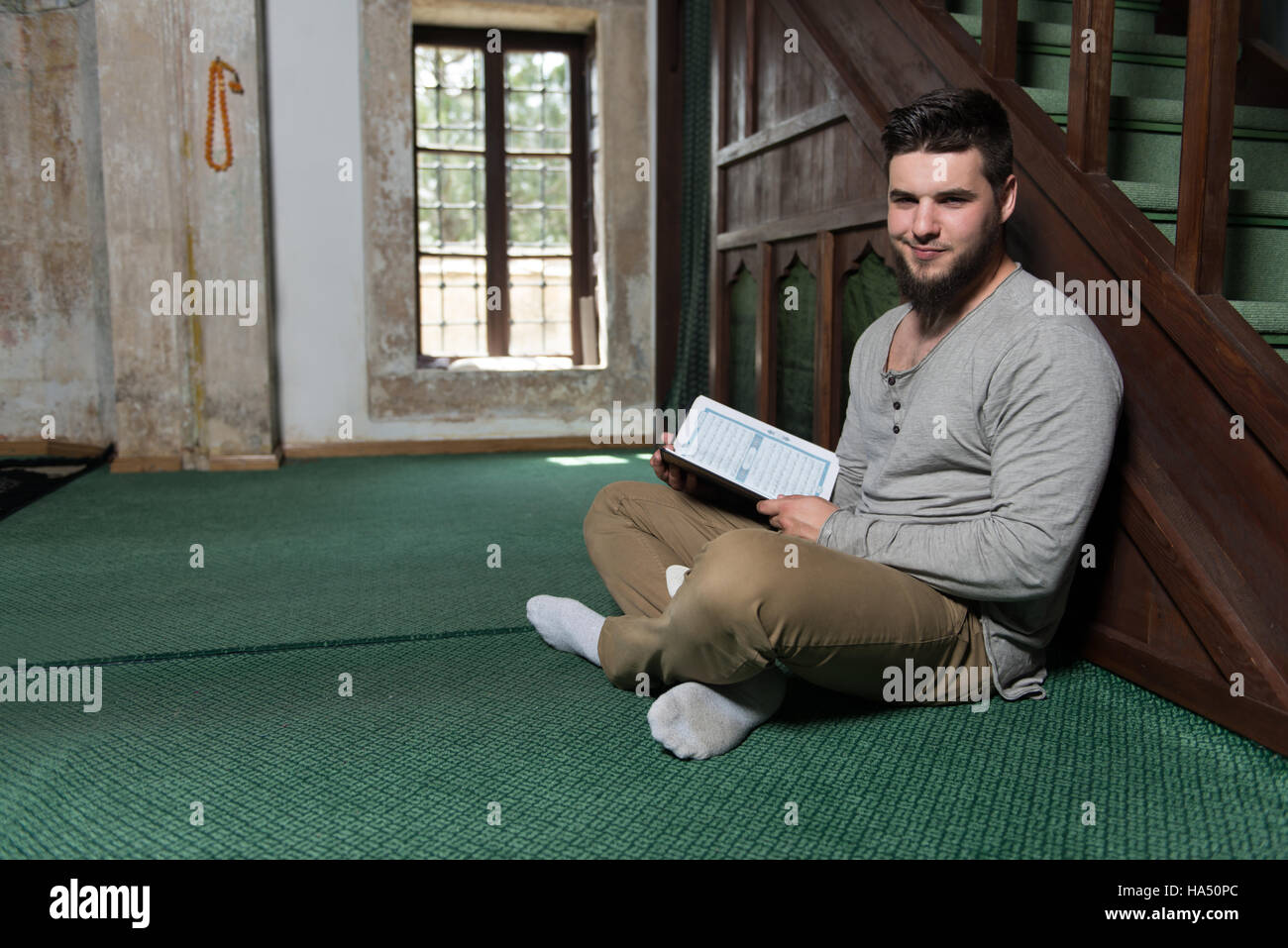 Adult Muslim Man Is Reading The Koran In The Mosque Stock Photo - Alamy