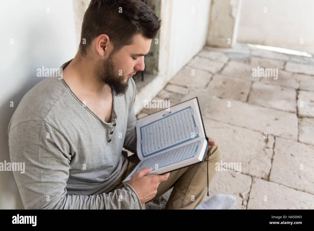 Humble Muslim Man Is Reading The Koran In The Mosque Outdoors Stock ...