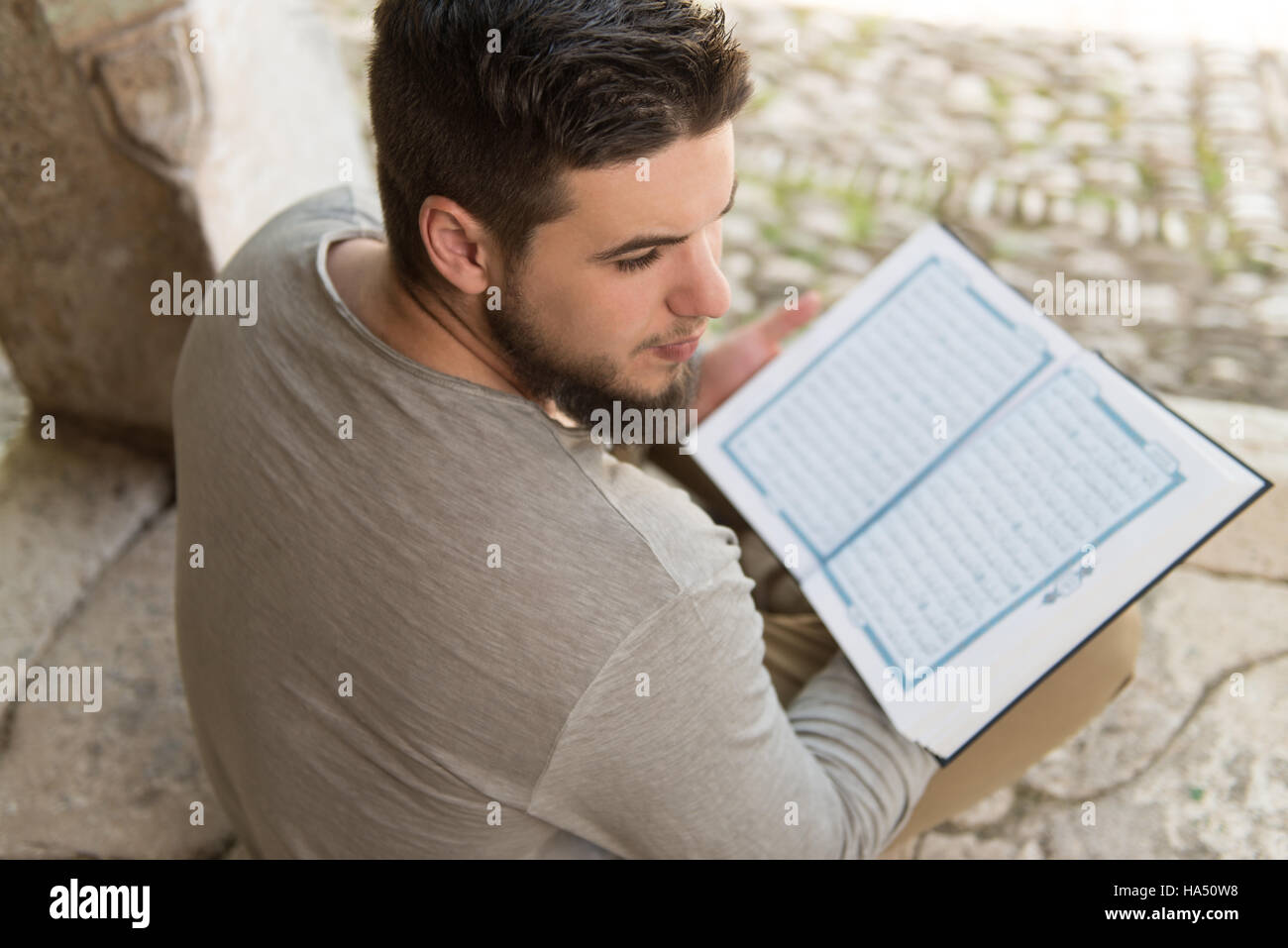 Humble Muslim Man Is Reading The Koran In The Mosque Outdoors Stock ...