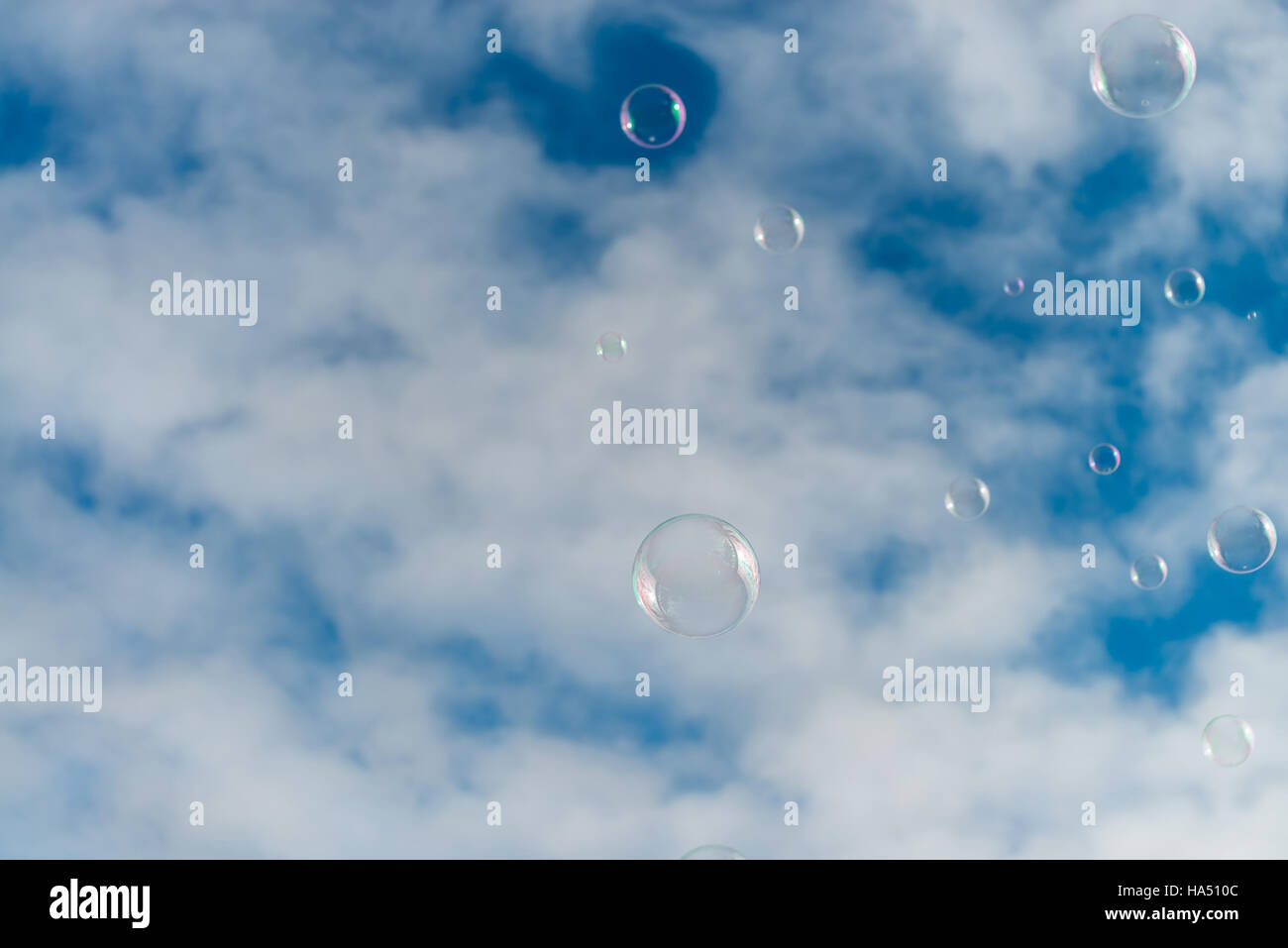 Soap bubbles flying in blue sky with clouds Stock Photo - Alamy