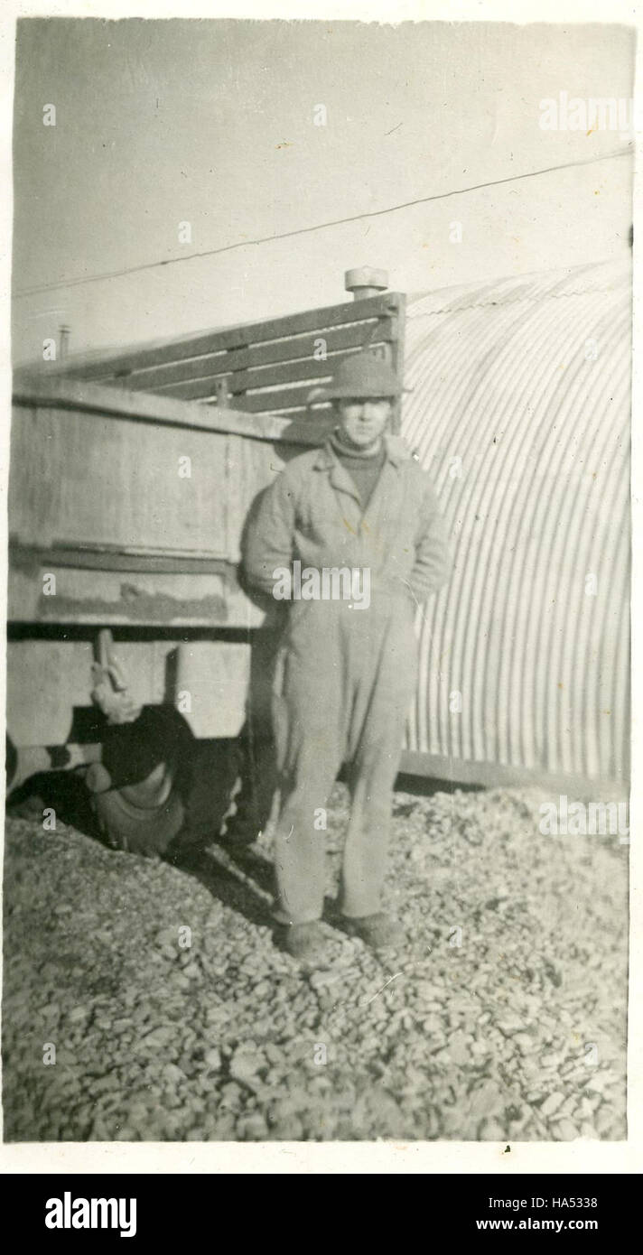An individual wearing coveralls and a helmet in an Alaskan environment ...