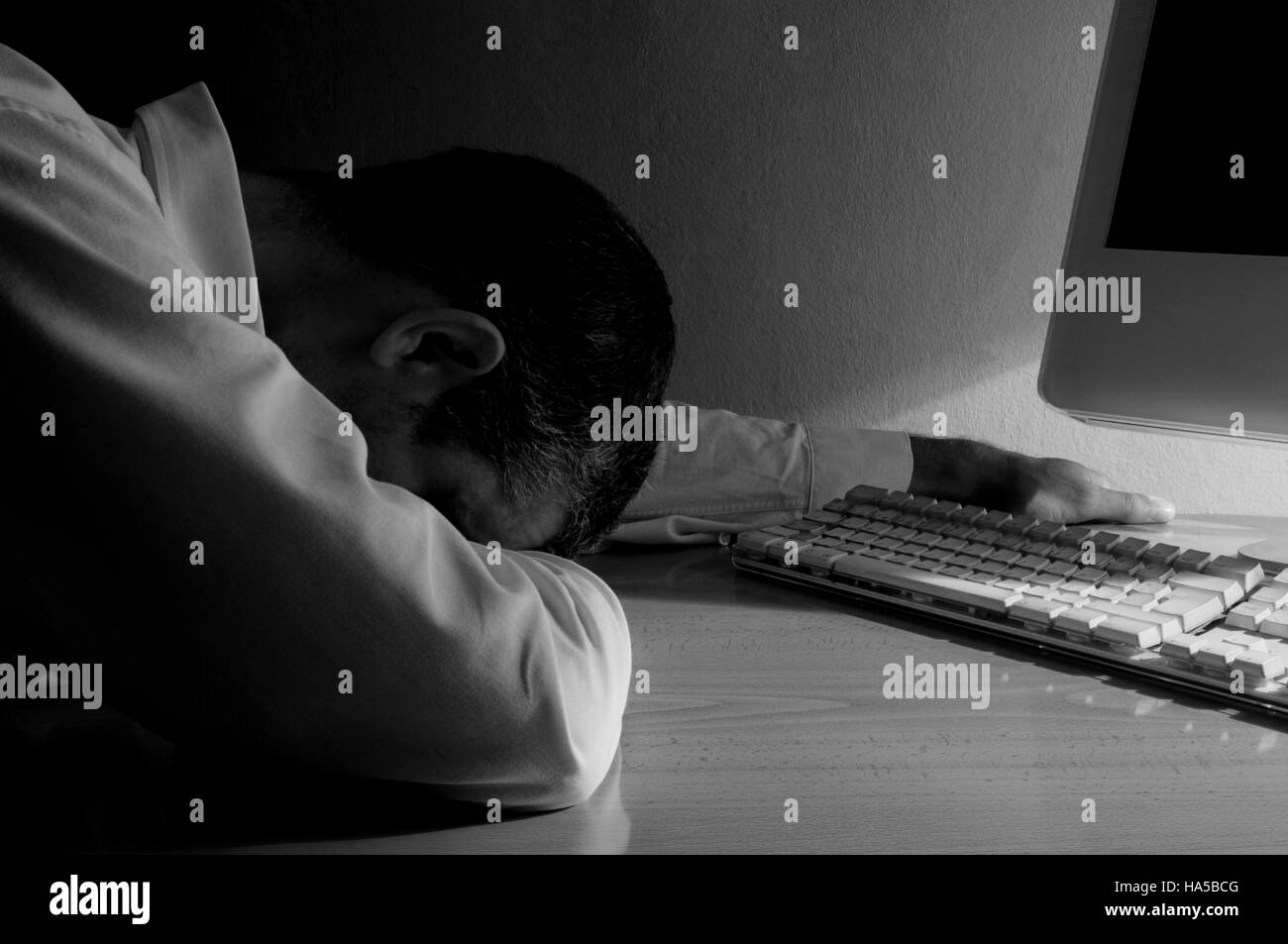 Depressed man at the computer. Black and white Stock Photo - Alamy