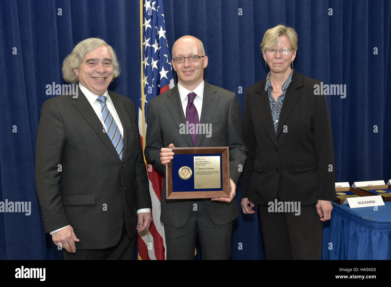 The image shows DOE Secretary E. Moniz with key figures, including ...