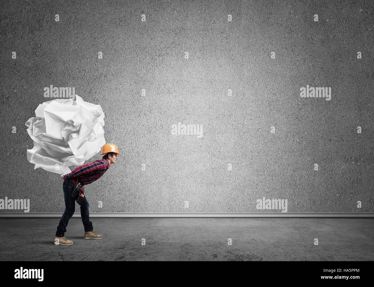 Builder man carrying paper ball on his back Stock Photo - Alamy