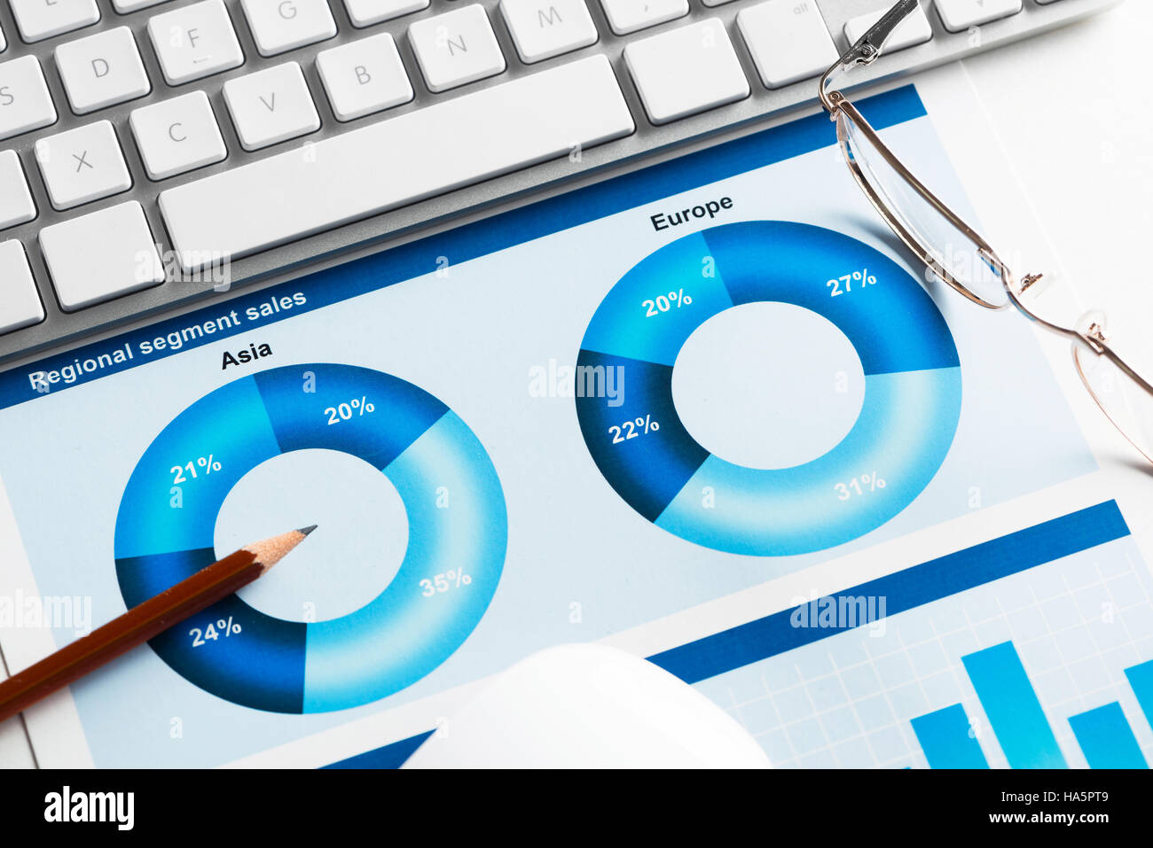 Business workplace with keyboard mouse and papers with graphs and ...