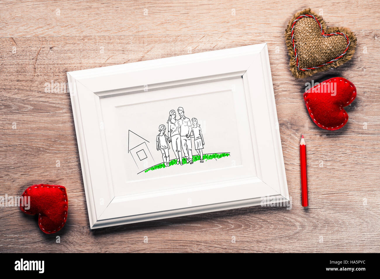 Photo frame with happy family drawing on wooden table Stock Photo - Alamy