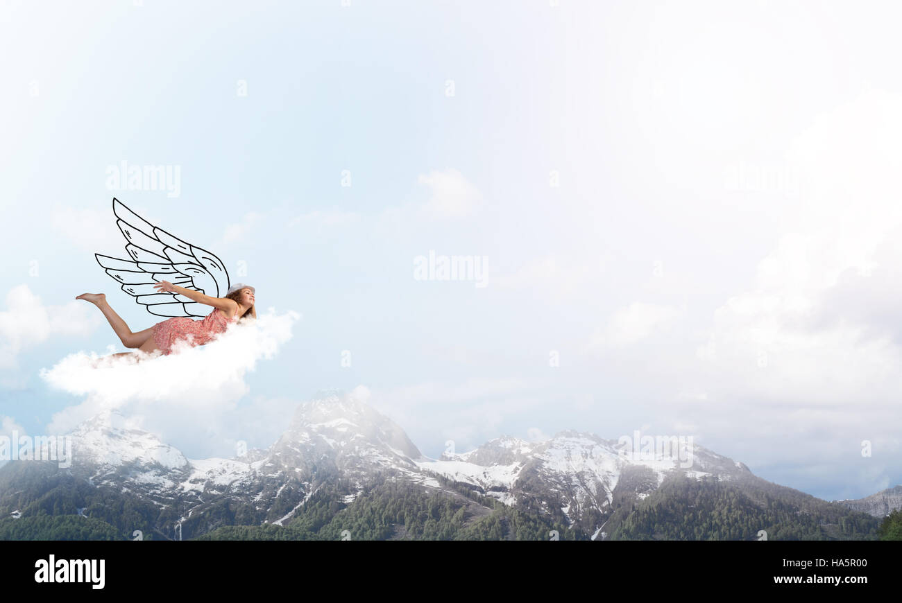 Young woman flying high in blue sky Stock Photo - Alamy