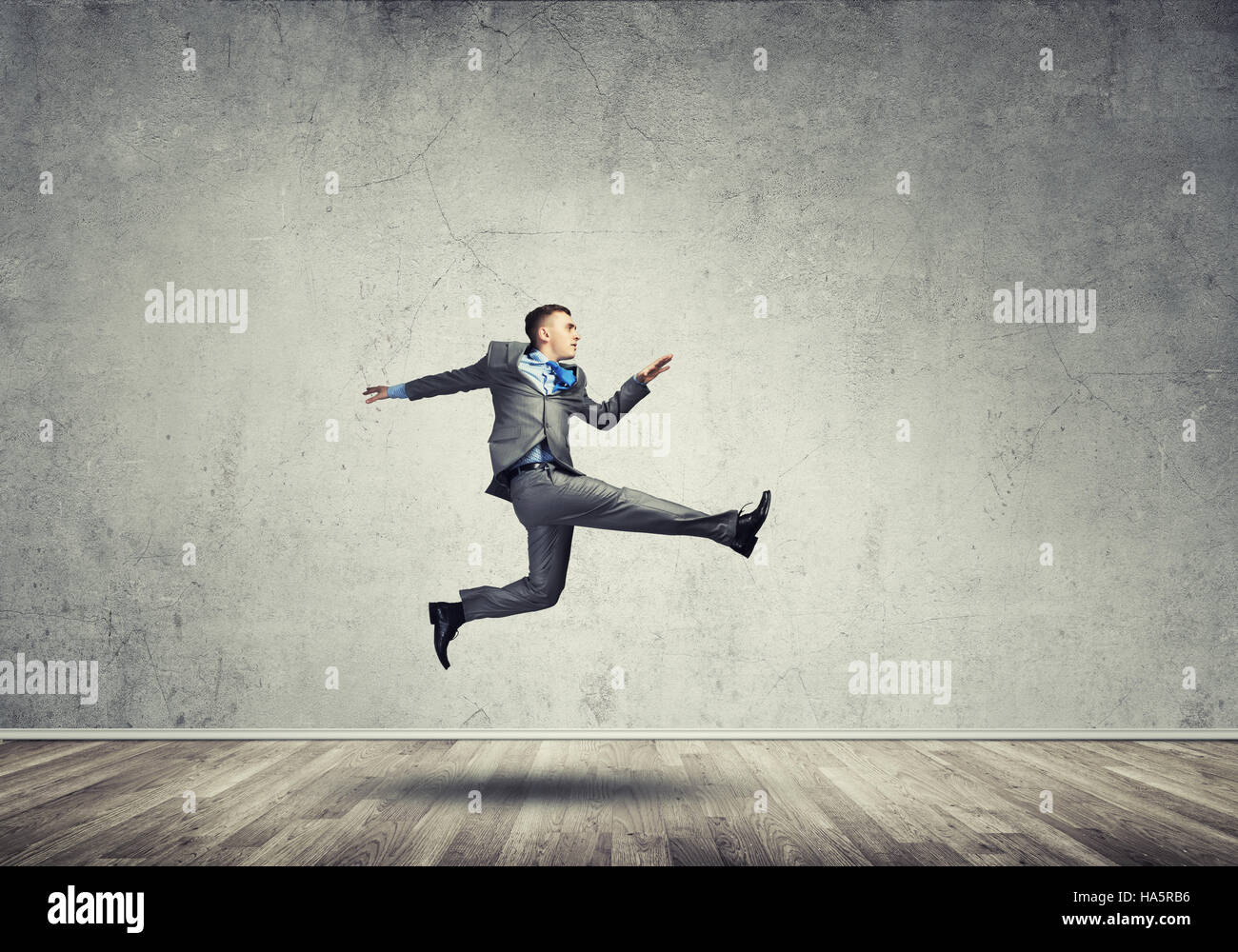 Young businessman in room running in a hurry Stock Photo - Alamy