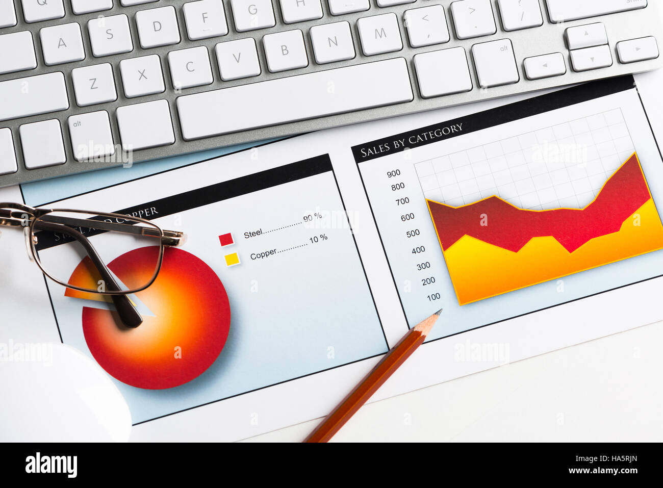 Business workplace with keyboard mouse and papers with graphs and ...