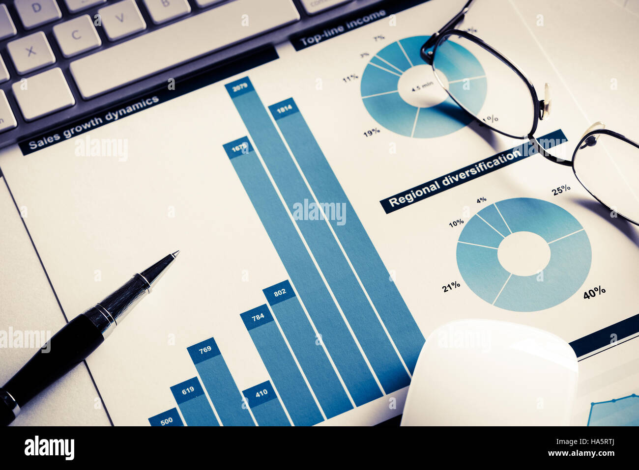 Business workplace with keyboard mouse and papers with graphs and ...