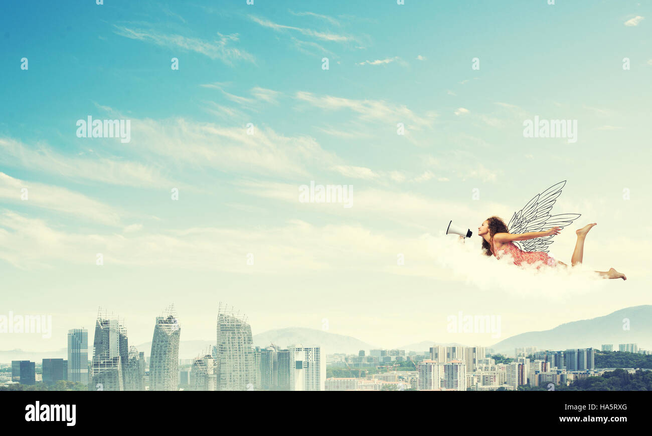Young woman with megaphone flying high in sky Stock Photo - Alamy