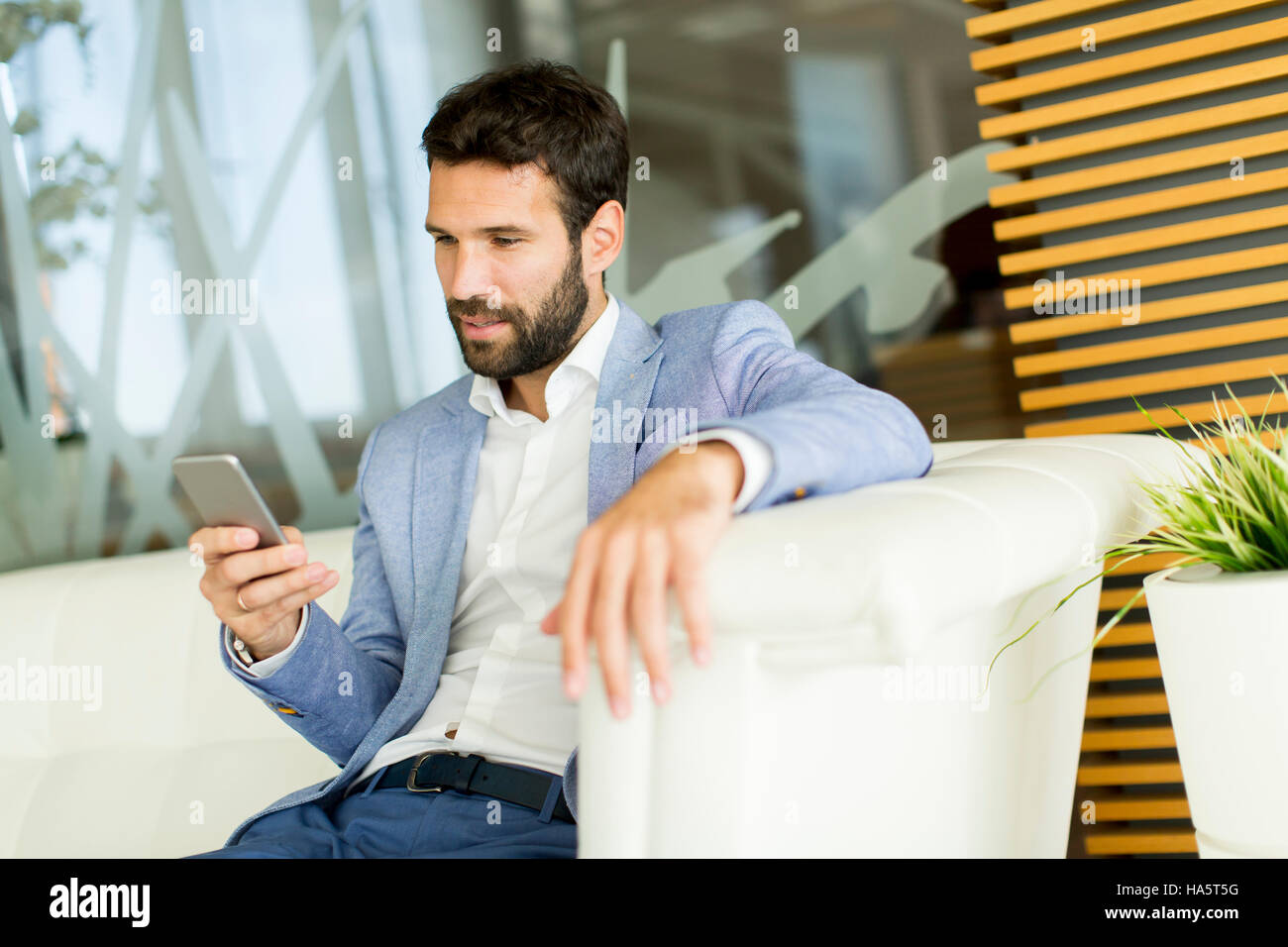 Handsome man sitting using hi-res stock photography and images - Alamy