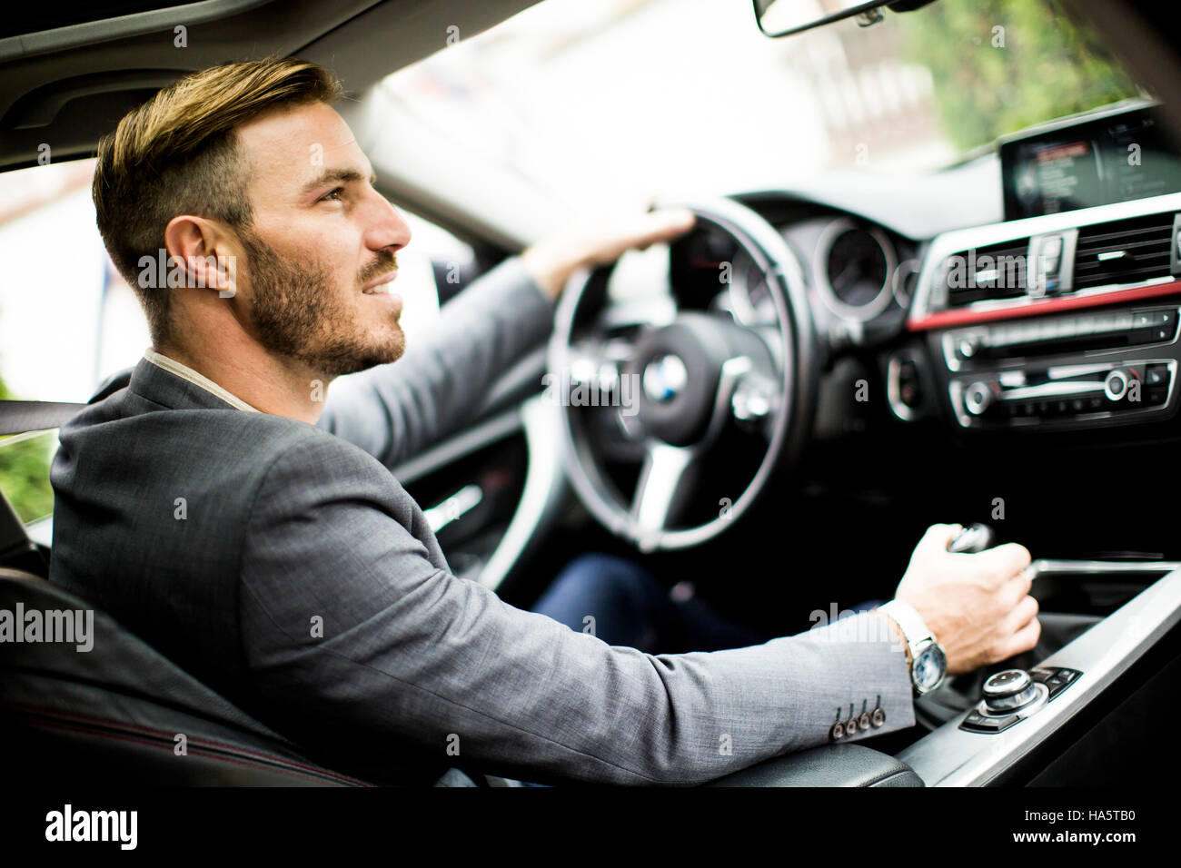 Young man driving in the modern car Stock Photo - Alamy