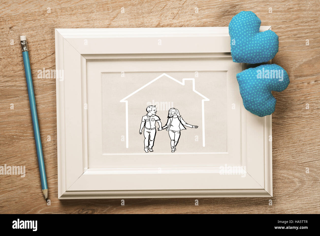 Photo frame with happy couple drawing on wooden table Stock Photo - Alamy