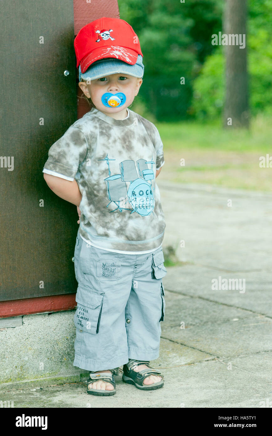 Young boy wearing two caps Stock Photo - Alamy