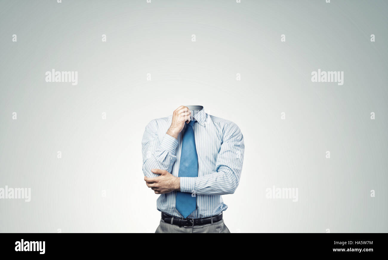 Businessman without head and his arm on chin thinking something over ...