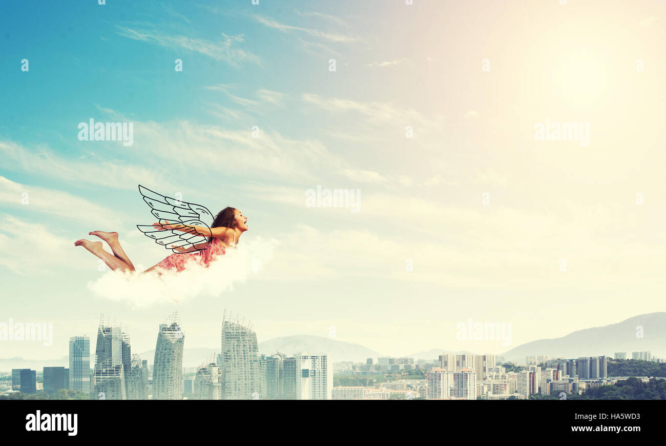 Young woman flying high in blue sky Stock Photo - Alamy