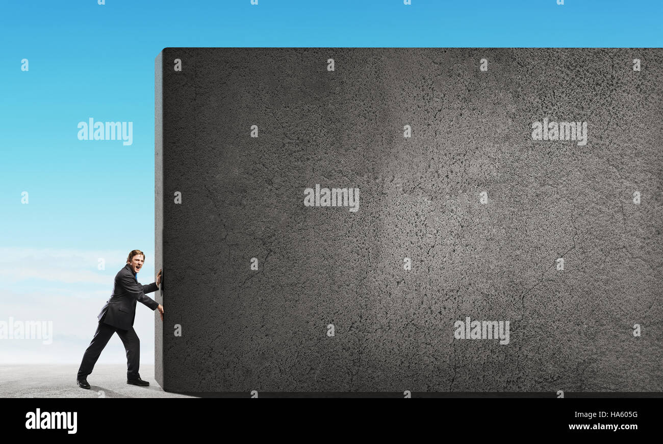Businessman push wall Stock Photo - Alamy