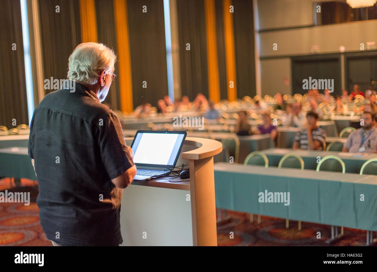 Senior public speaker giving talk at scientific conference Stock Photo ...