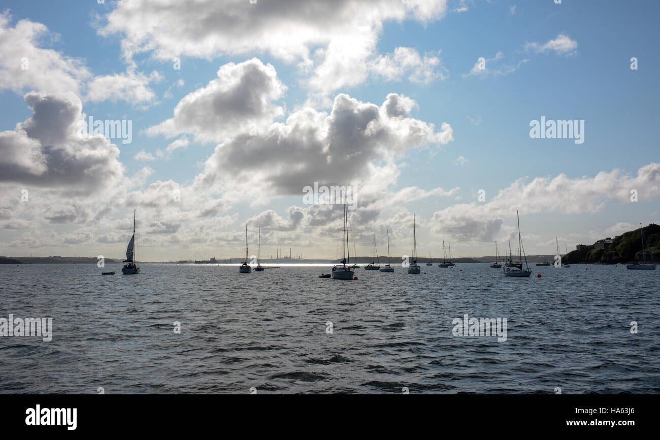 Sailing boats at anchor under a blue sky with white clouds in Dale bay ...