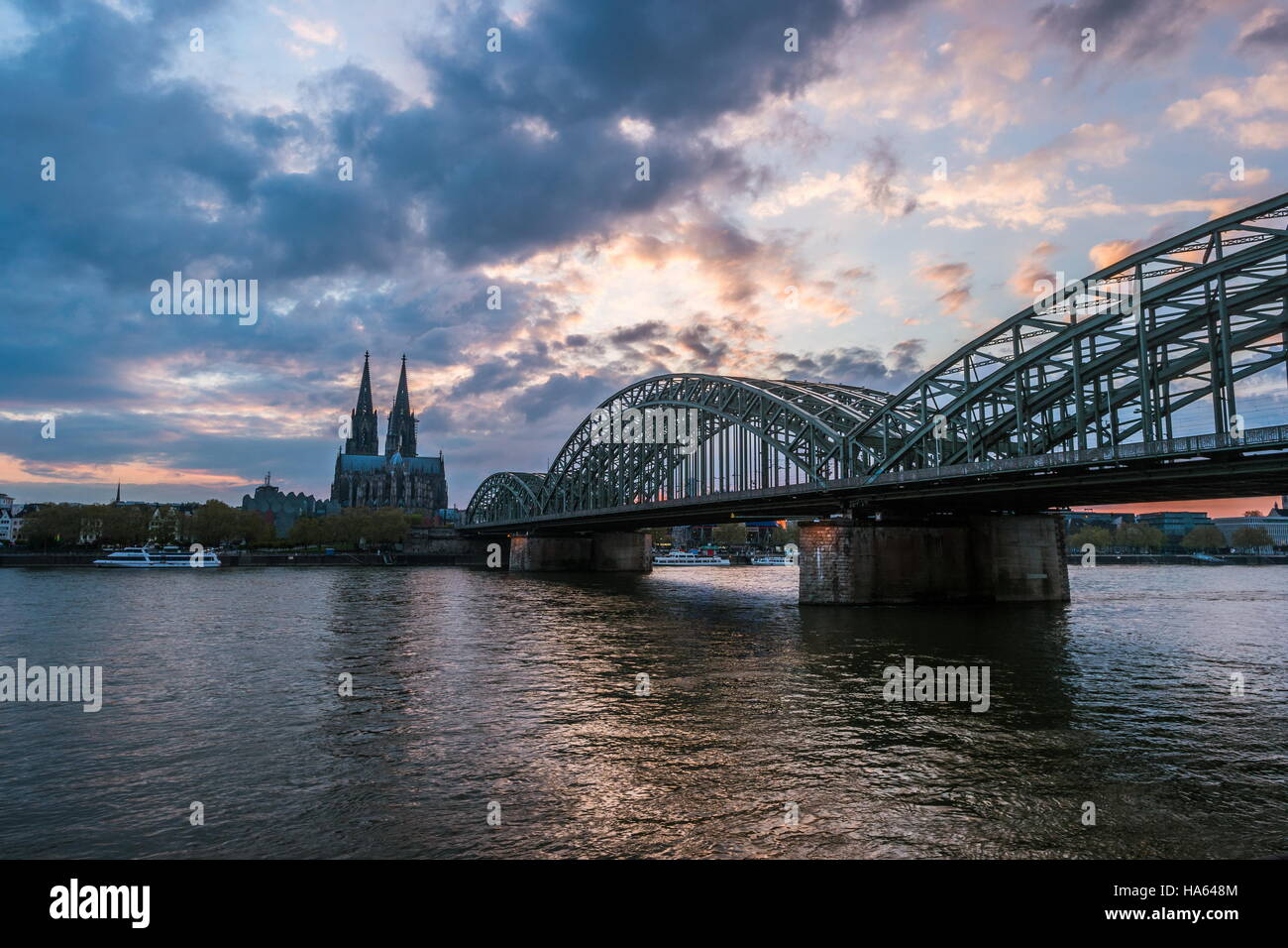 Sunset view of Cologne Cathedral and Hohenzollern Bridge Stock Photo ...