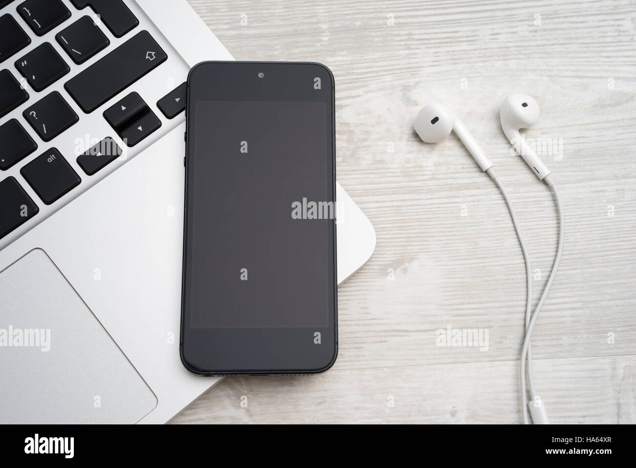 Smartphone on the table with earphone Stock Photo - Alamy