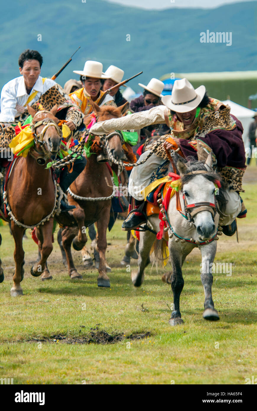 Khampa horseman, wearing snow leopard pelts, race their horses at the ...