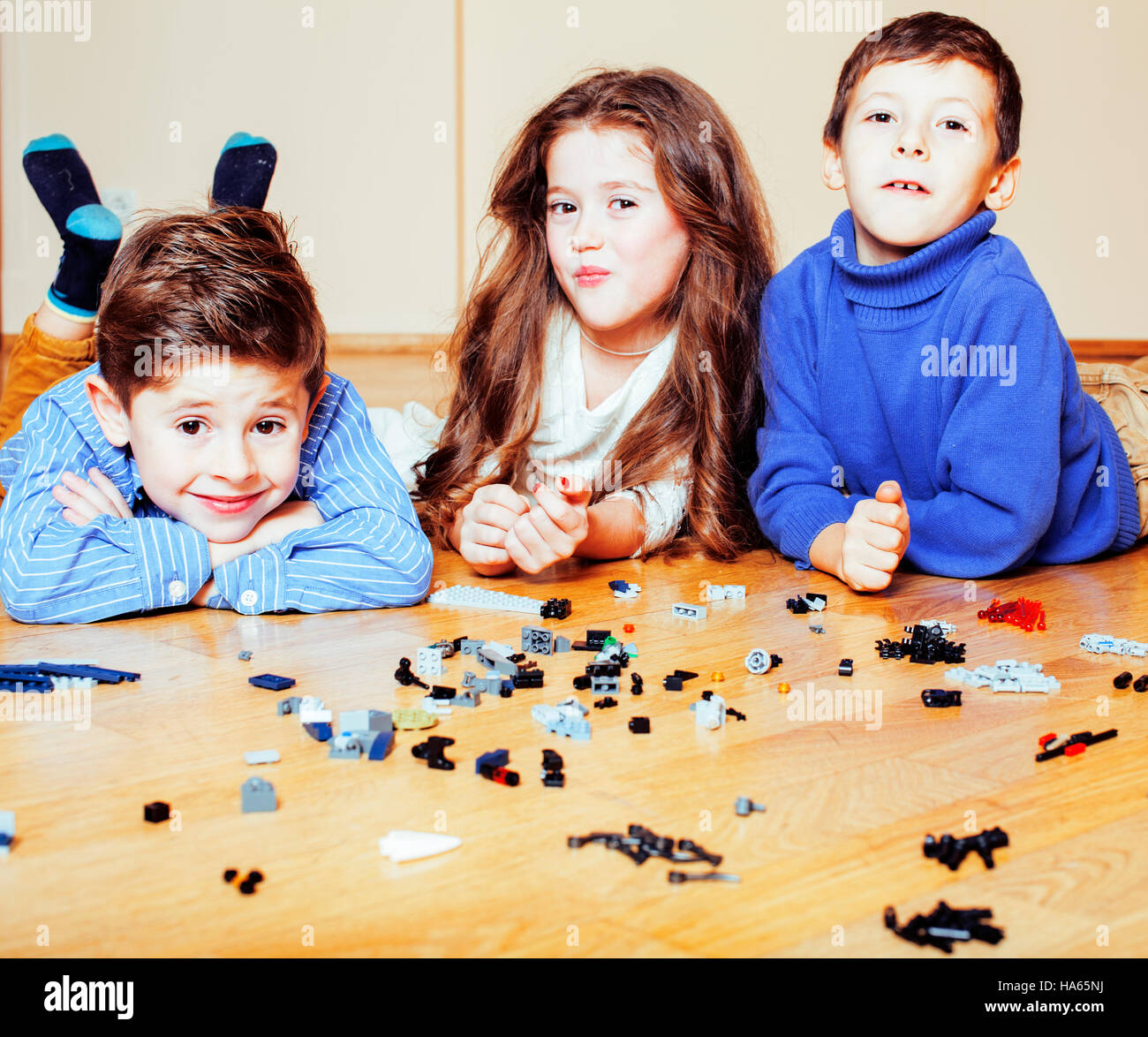 funny cute children playing lego at home, boys and girl smiling, first ...