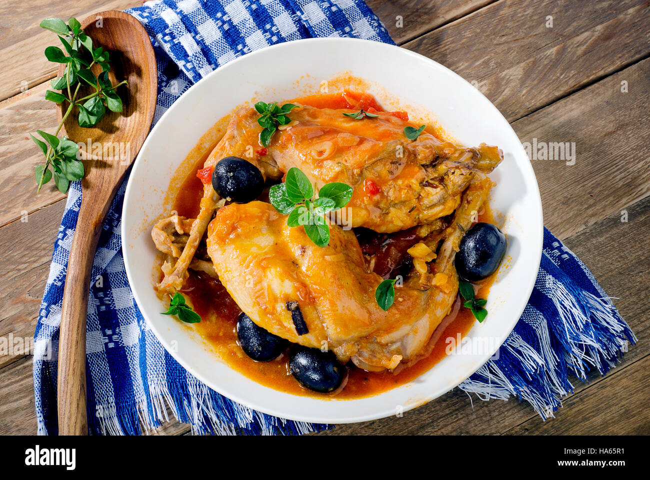 Stewed rabbit legs with black olives and fresh herbs. Top view Stock ...