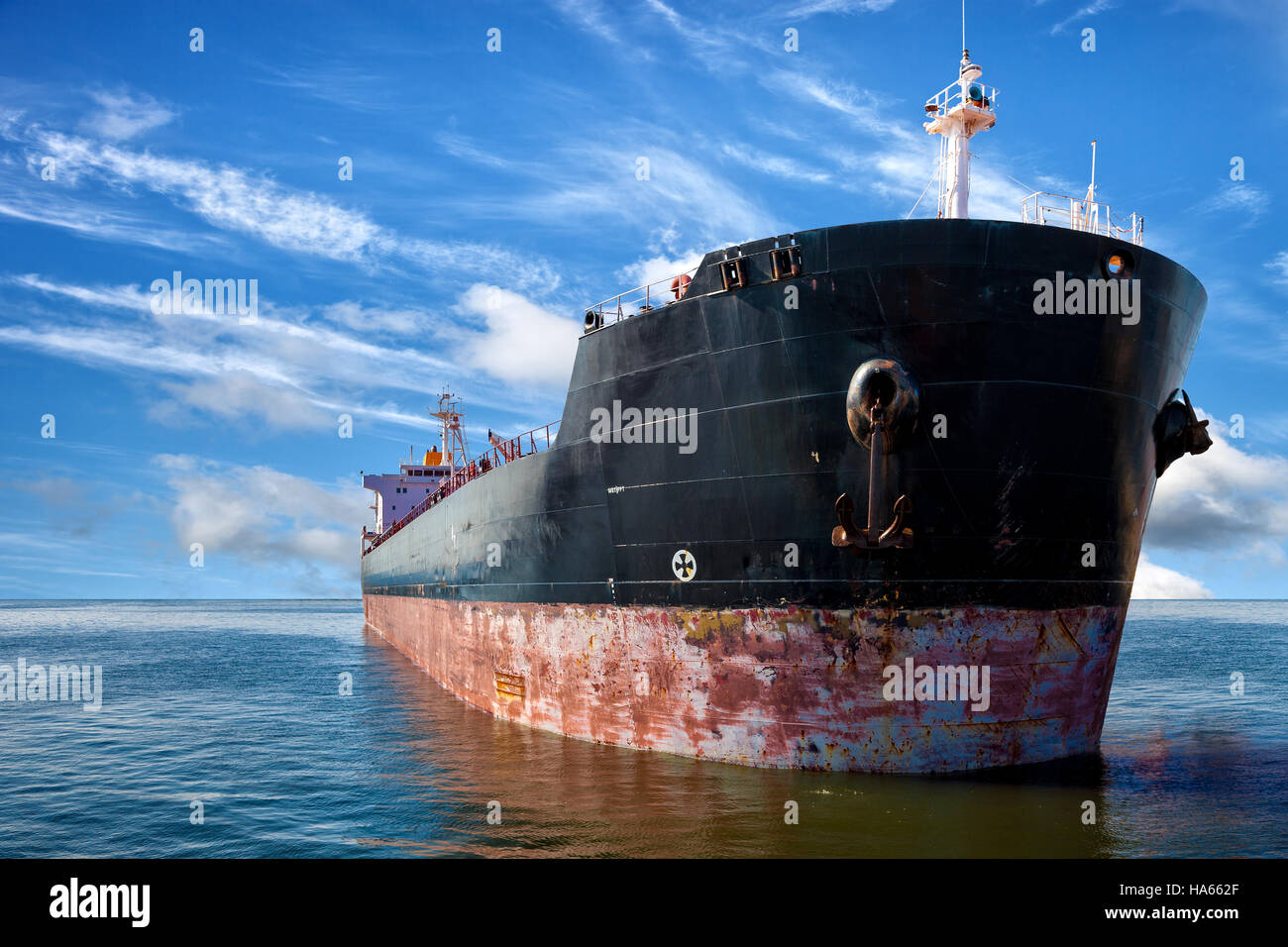 Oil tanker ship at sea on a background of blue sky Stock Photo - Alamy