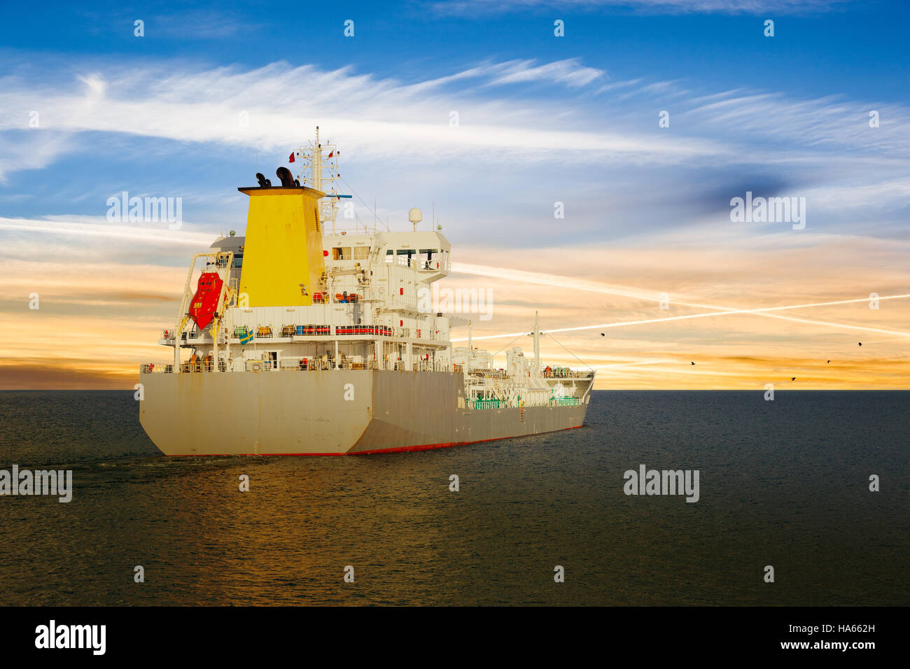 Tanker ship sailing in the sea on sunset Stock Photo - Alamy