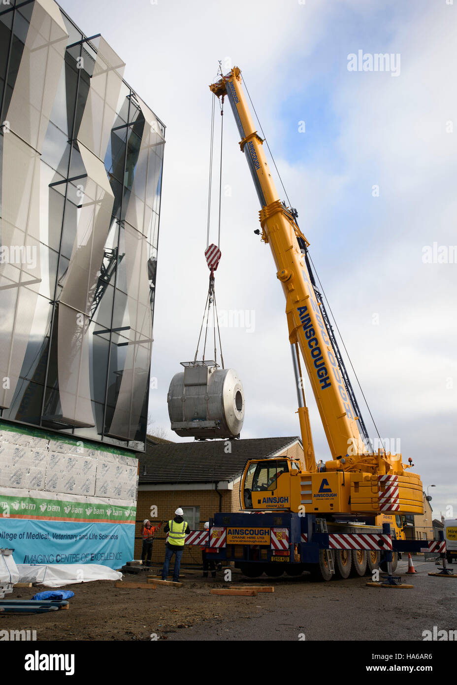 A crane lifts an ultra-powerful Â£10 million magnetic resonance imaging ...