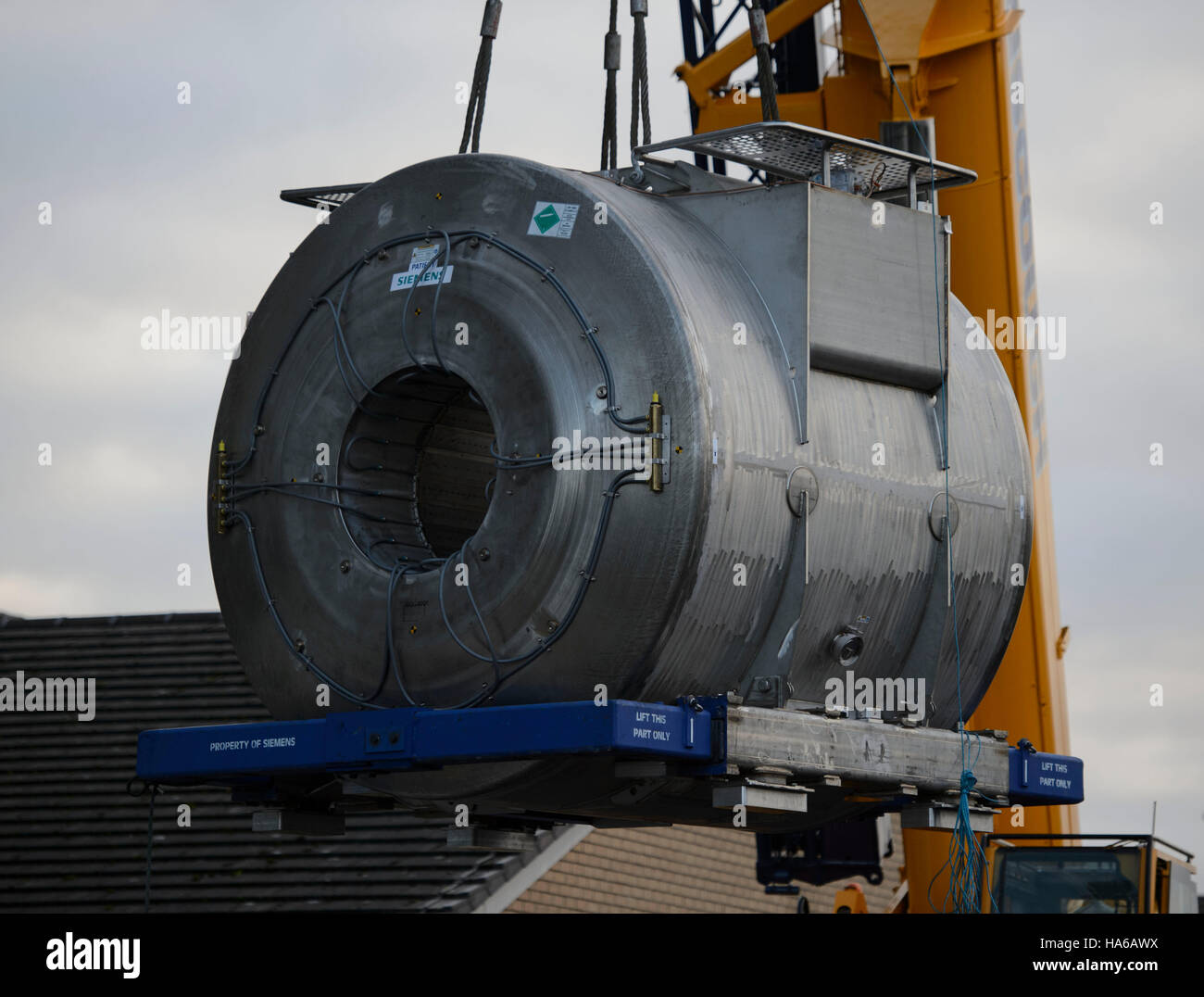 A crane lifts an ultra-powerful Â£10 million magnetic resonance imaging ...